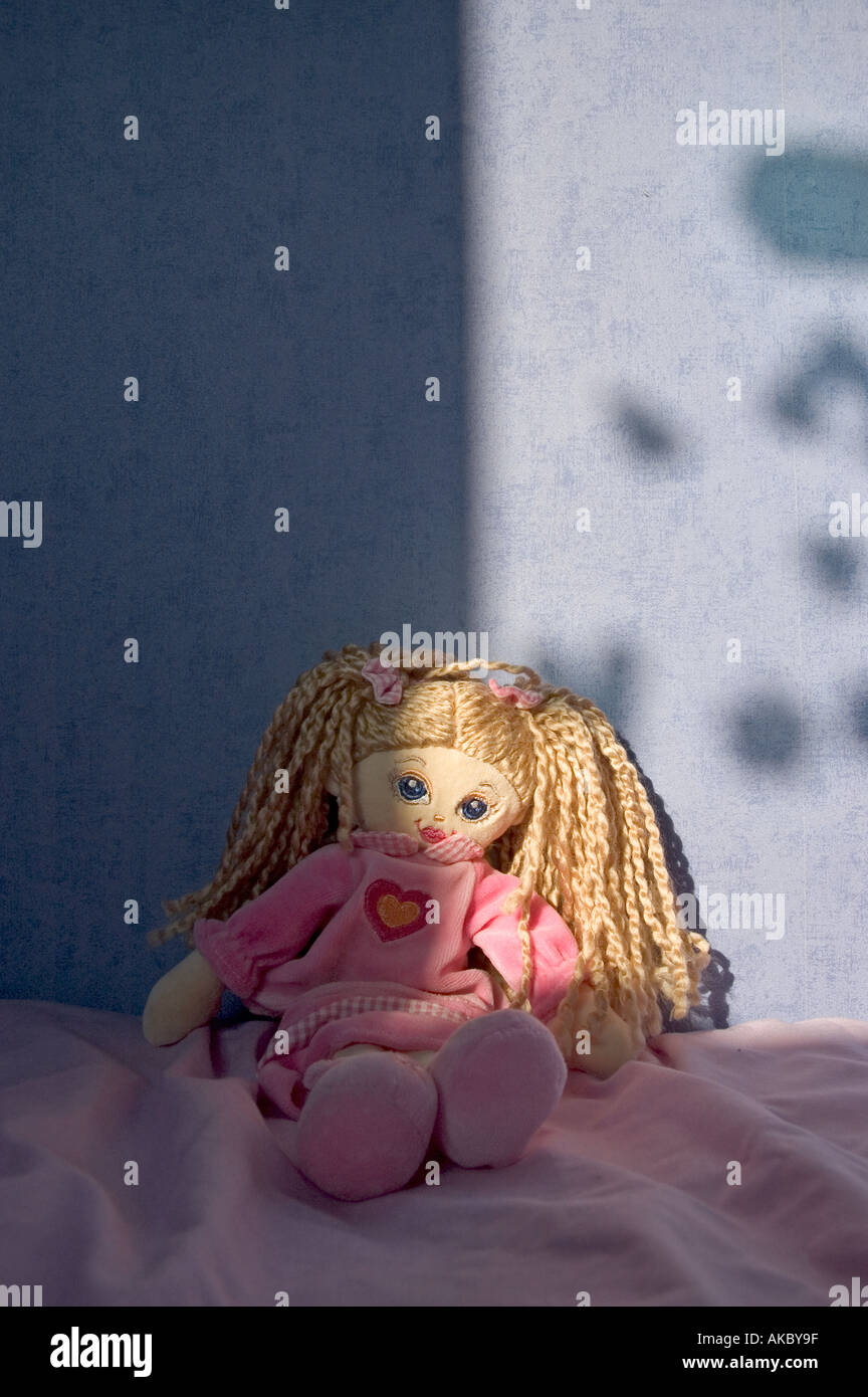 A childs doll alone in a bedroom Stock Photo - Alamy