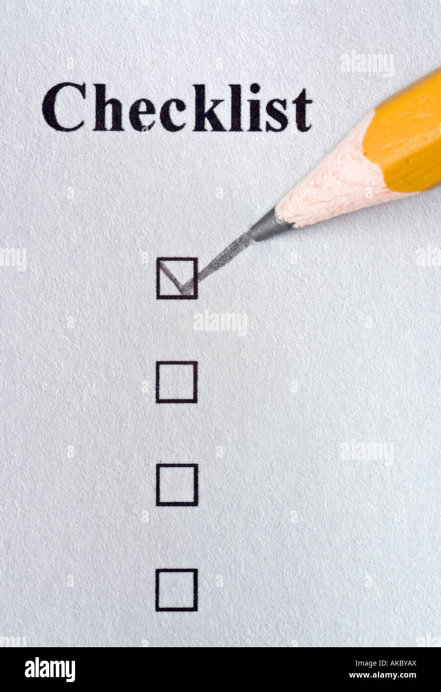 Checklist being filled out in pencil with texture showing in paper ...