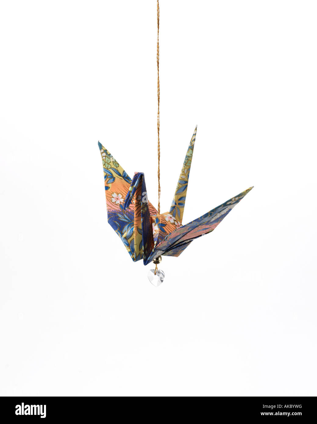 origami crane hanging on gold thread used as a Christmas tree ornament ...