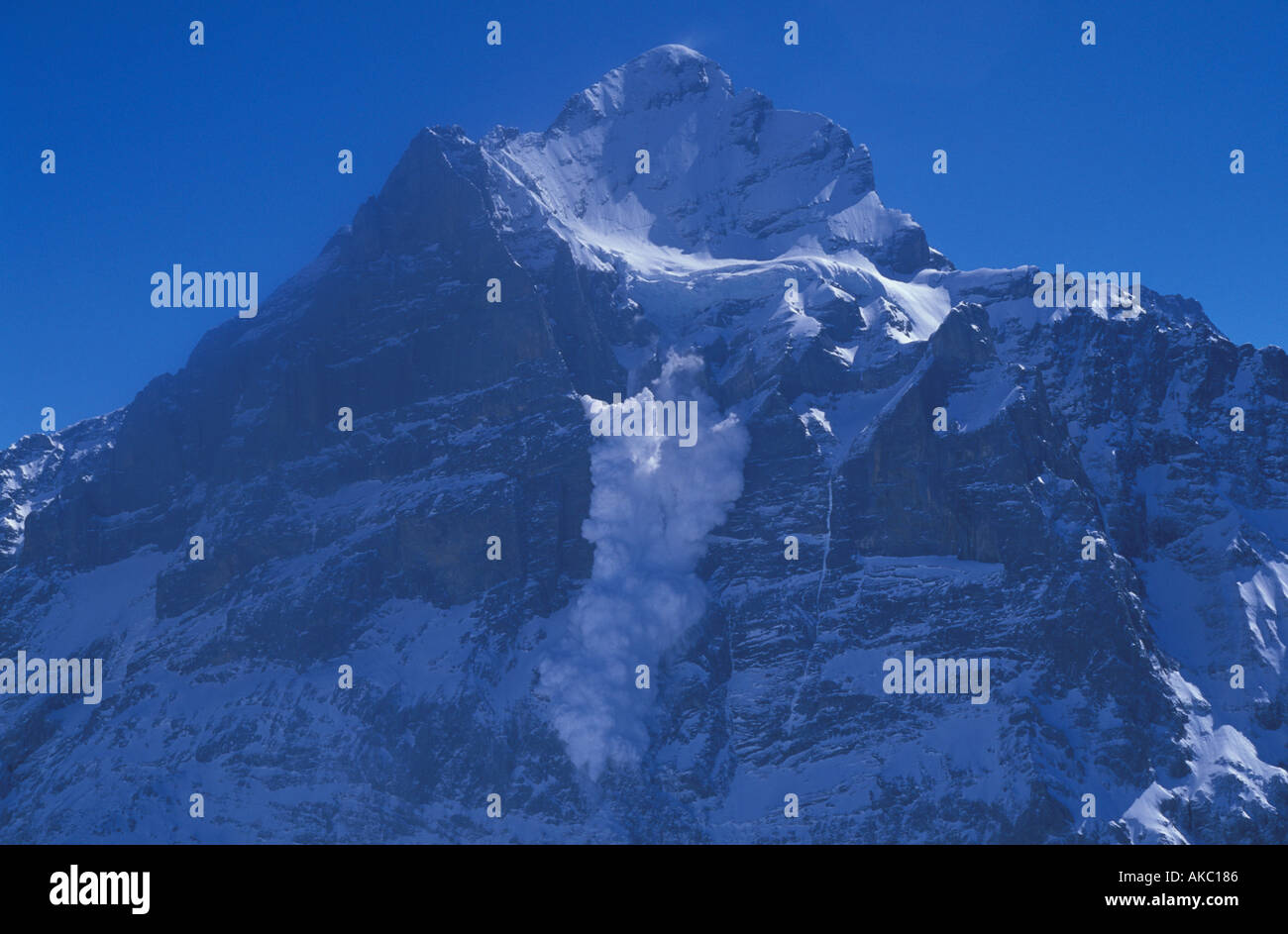 Ice avalanche braking loose from hanging glacier on Mt Wetterhorn above ...