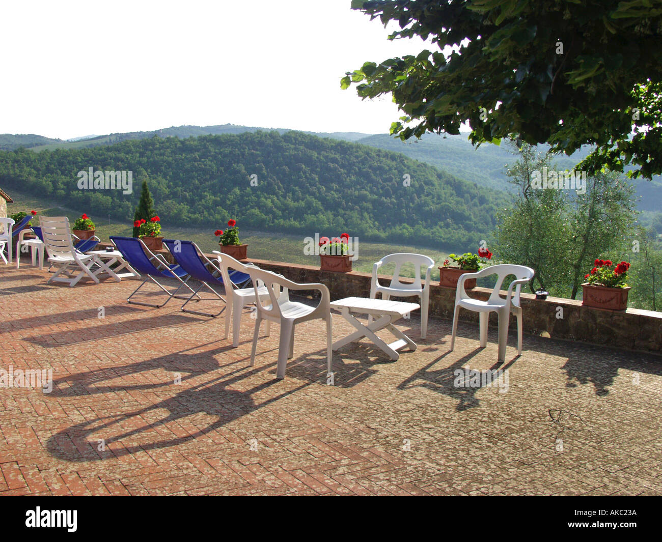 Early morning sunlight rises over the patio of an Italian villa in ...