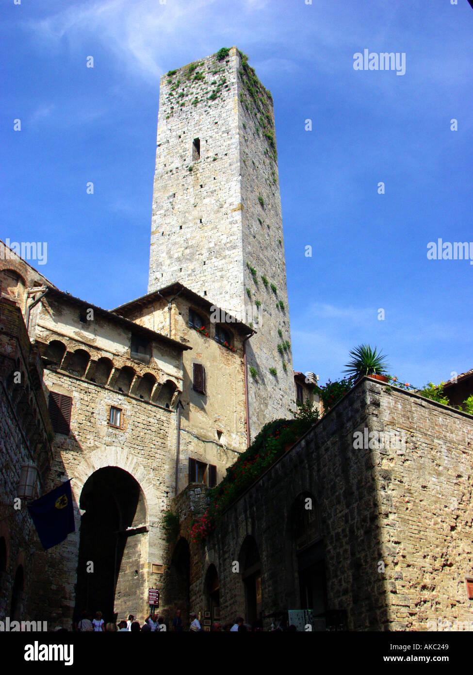 Visitors throng through the inner city wall entrance below one of San ...