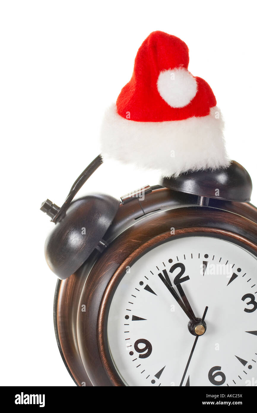 Partial view of alarm clock with christmas hat Stock Photo - Alamy
