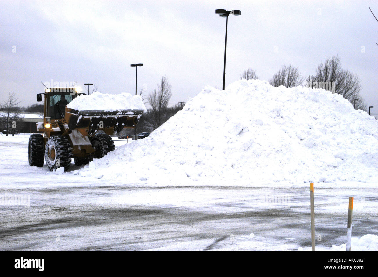 Front loader clearing parking lot of snow Stock Photo - Alamy