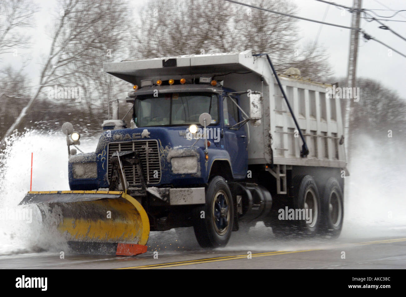Dump truck snowplow in operation during storm Stock Photo - Alamy
