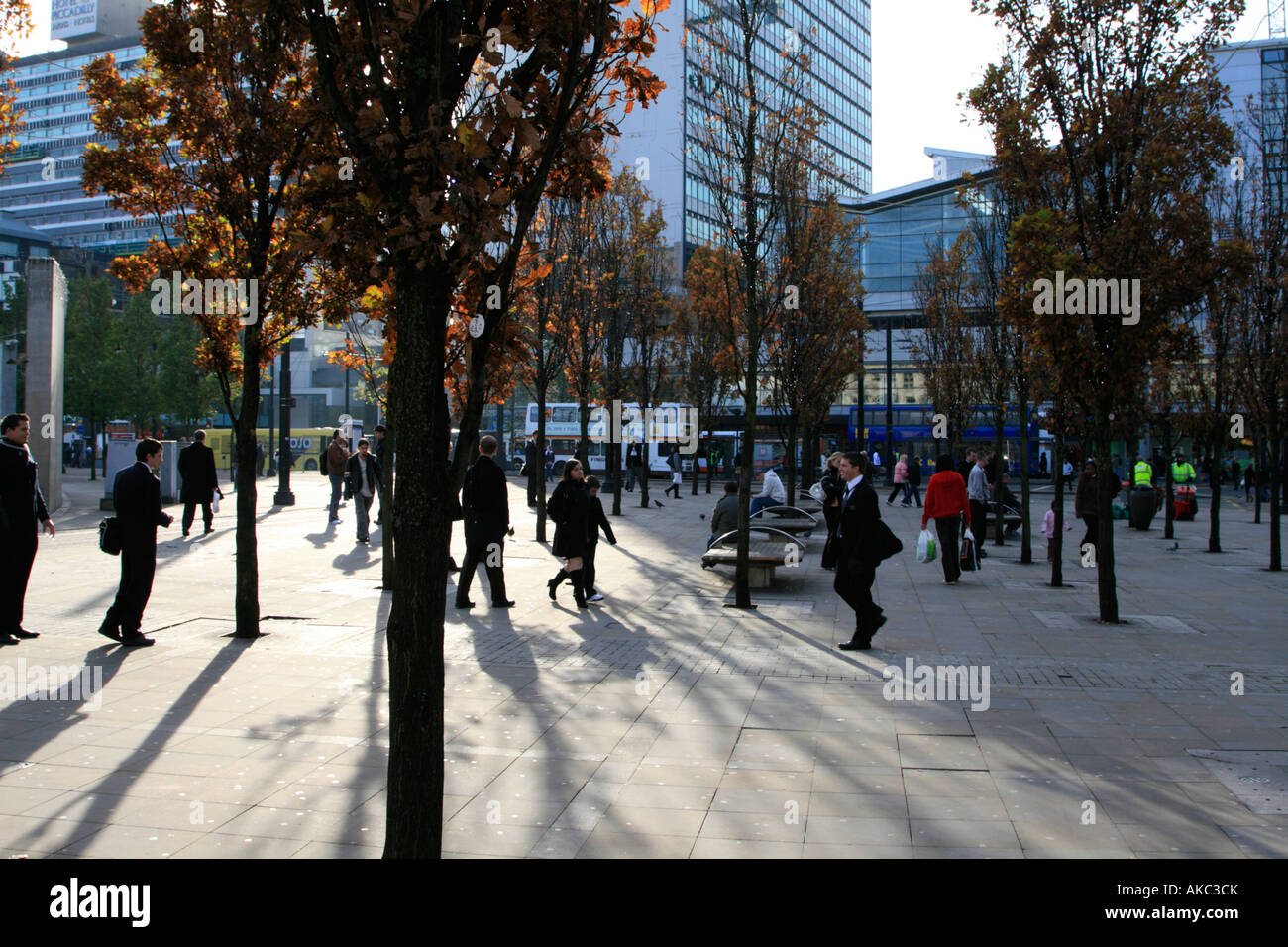 busy shoppers people walking manchester piccadilly gardens city tower ...