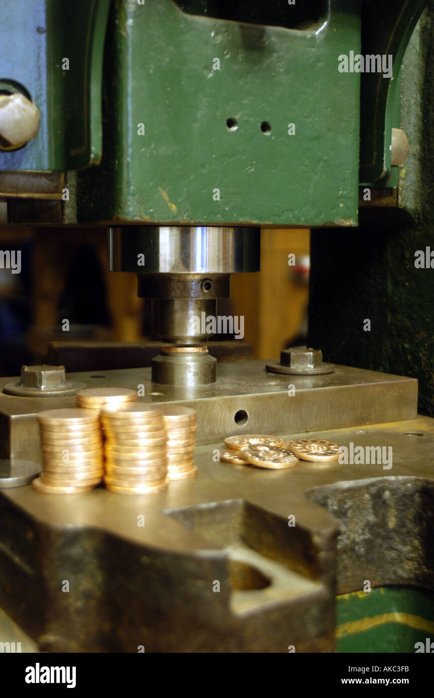 Closeup of coin being made with old coin press Stock Photo - Alamy