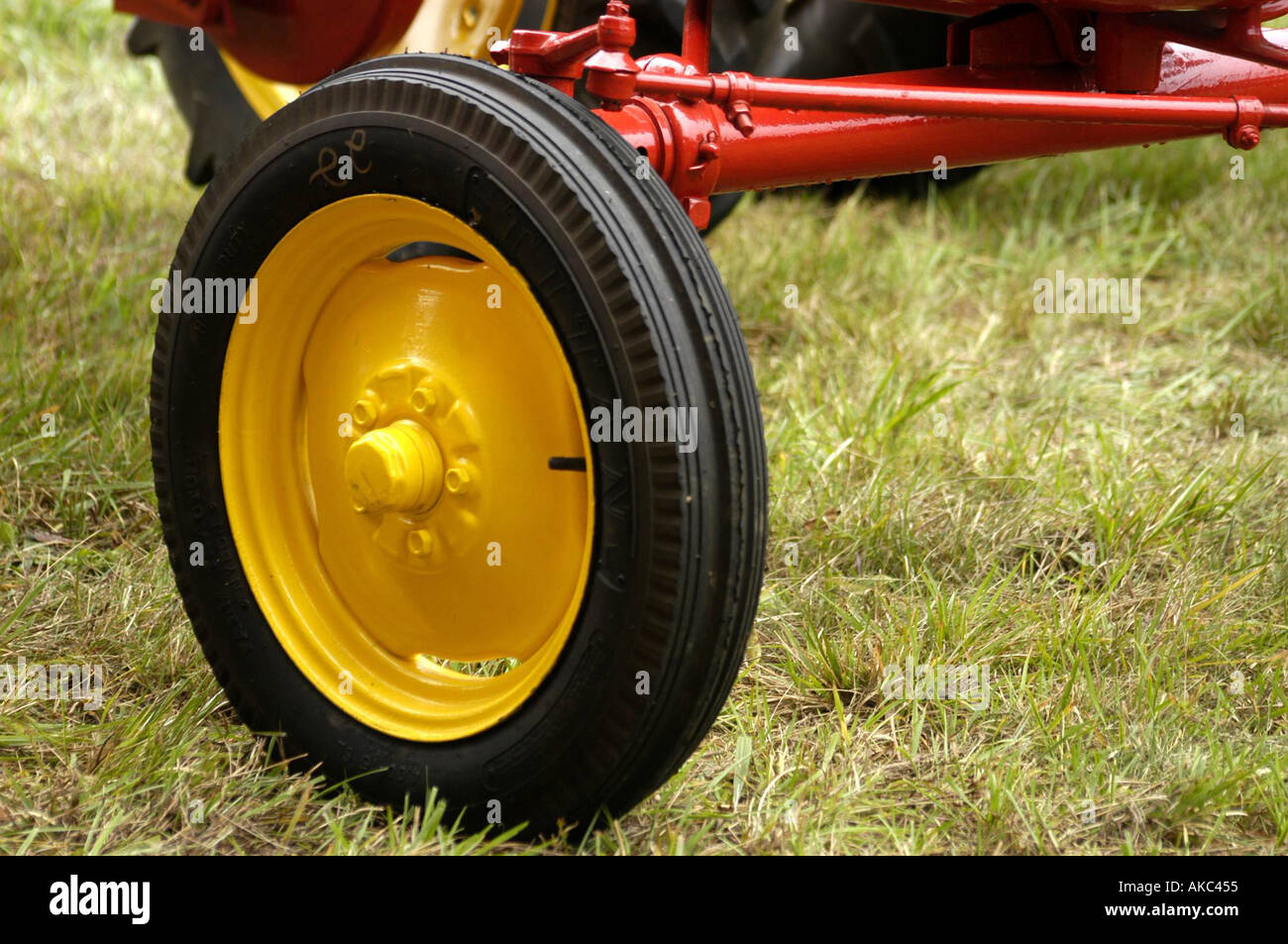 Closeup of front wheel of old farm tractor Stock Photo - Alamy