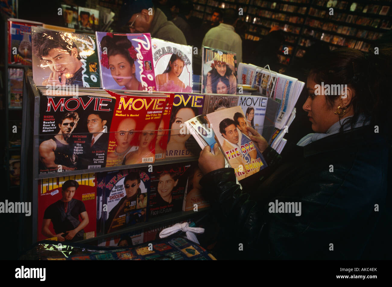 A female British Asian Bollywood movie fan avidly reads magazines from ...