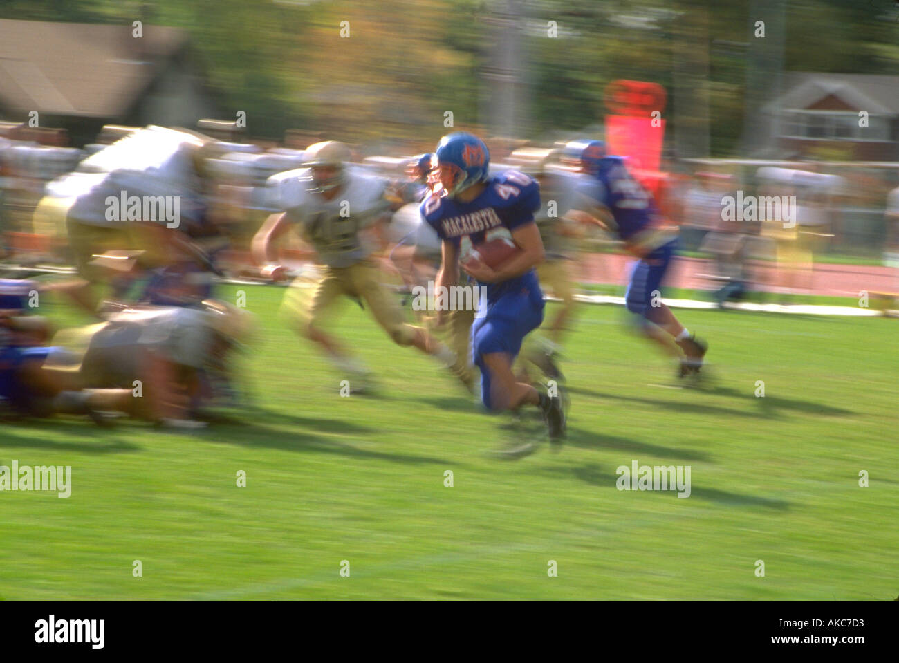 Blurred running back age 21 going around end at Macalester football ...