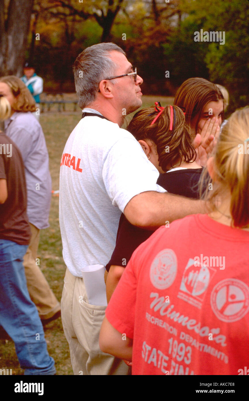 Coach consoling crying runner after losing race age 40 and 16. St Paul ...