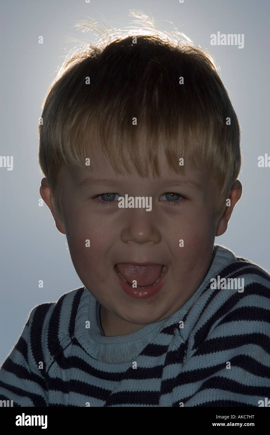 Backlit Smiling Four Year Old Boy Outdoors Stock Photo - Alamy