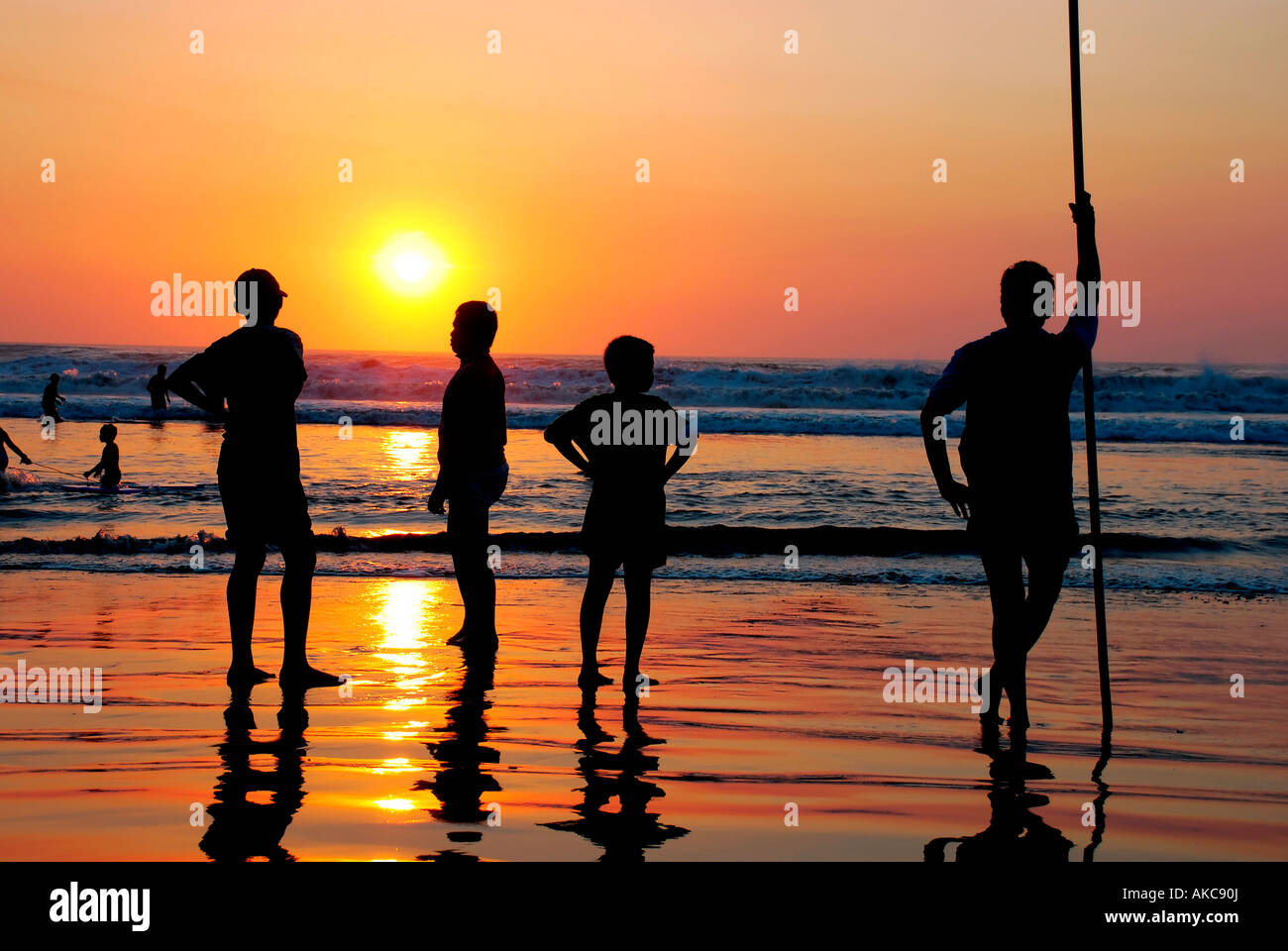 Silhouette people watching sunset by the beach Stock Photo - Alamy