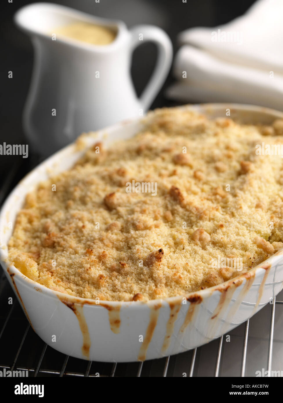 A whole English apple crumble with custard traditional dessert ...