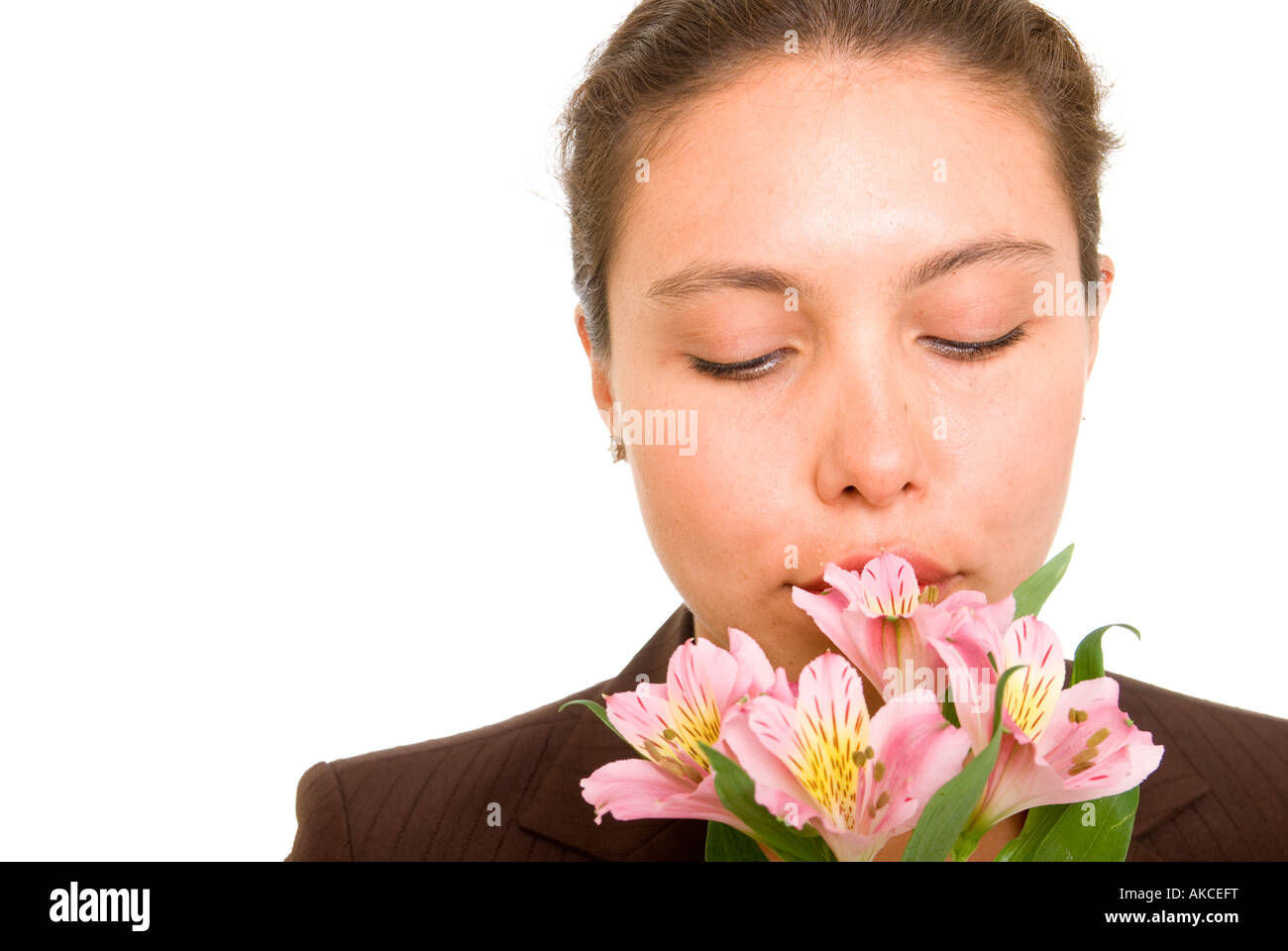 a young South American female smelling a bunch of pink lilies Stock ...