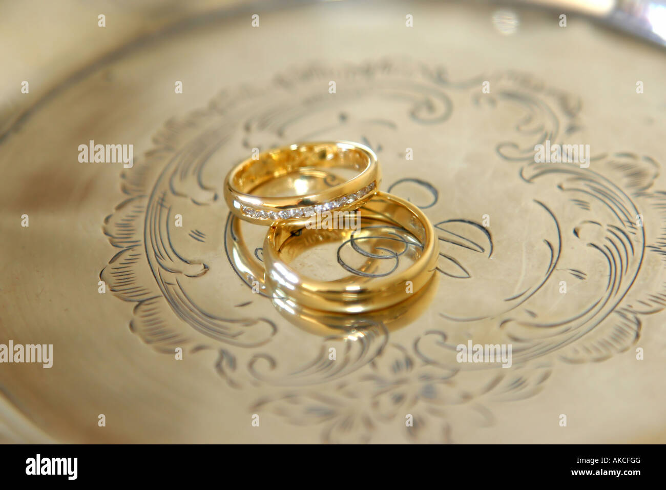 wedding rings on a silver plate Stock Photo - Alamy