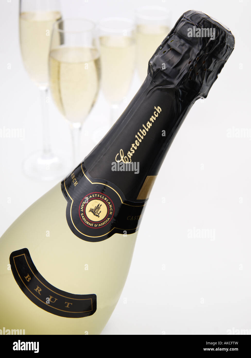 A bottle of cava blanc Spanish sparkling wine with glasses on a white ...