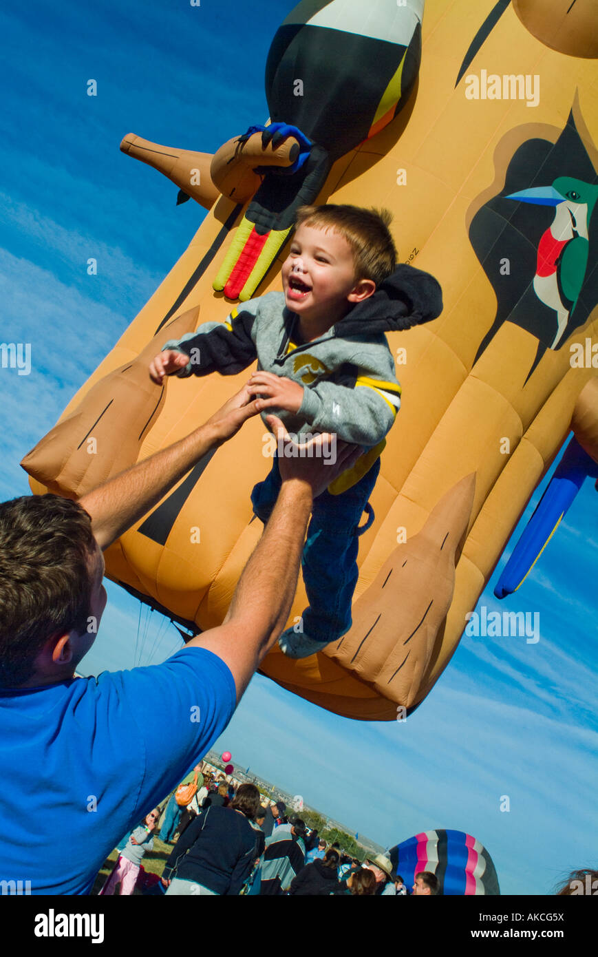 Young boy being thrown into air by father Stock Photo - Alamy