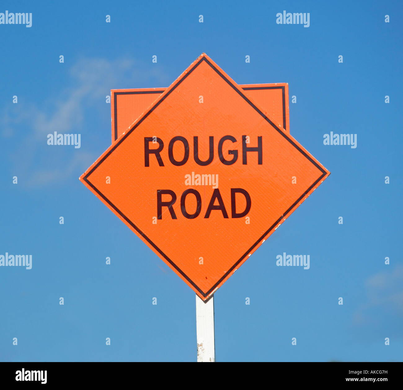 ROUGH ROAD SIGN TRAFFIC SIGN CAUTION BEWARE HARD TIMES BLUE SKY ROUGH ROAD SIGN TRAFFIC SIGN CAUTION BEWARE HARD TIMES BLUE SKY