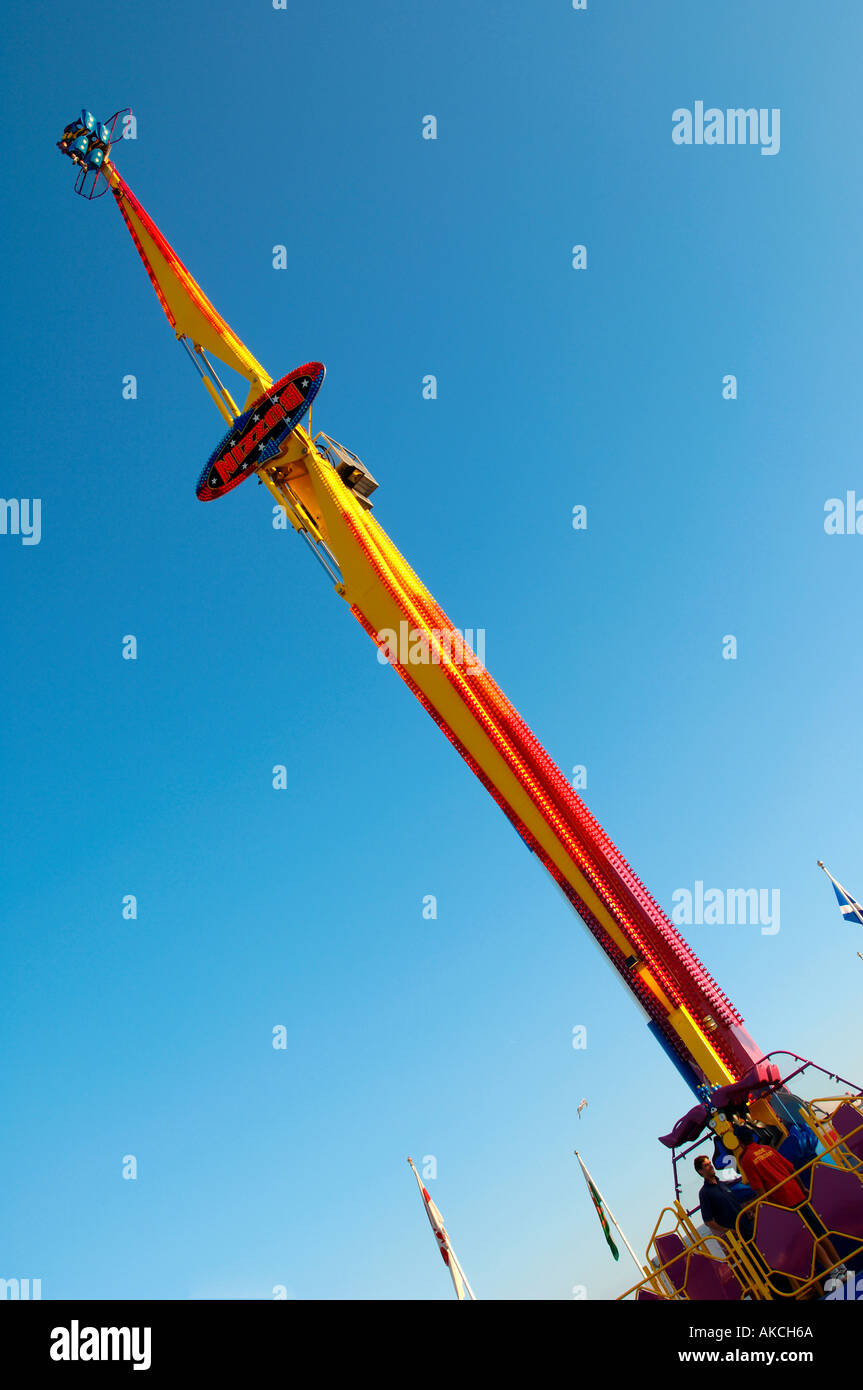People suspended in the air on a fairground ride very colourful highly ...