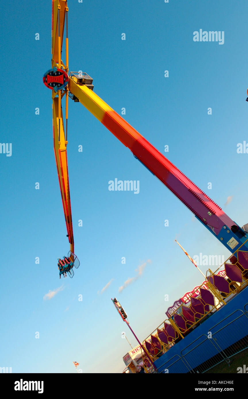 People suspended in the air on a fairground ride very colourful highly ...