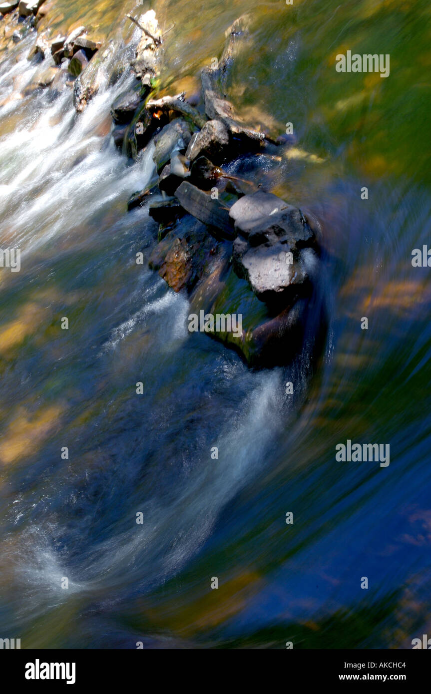 River flowing around exposed rocks Stock Photo - Alamy