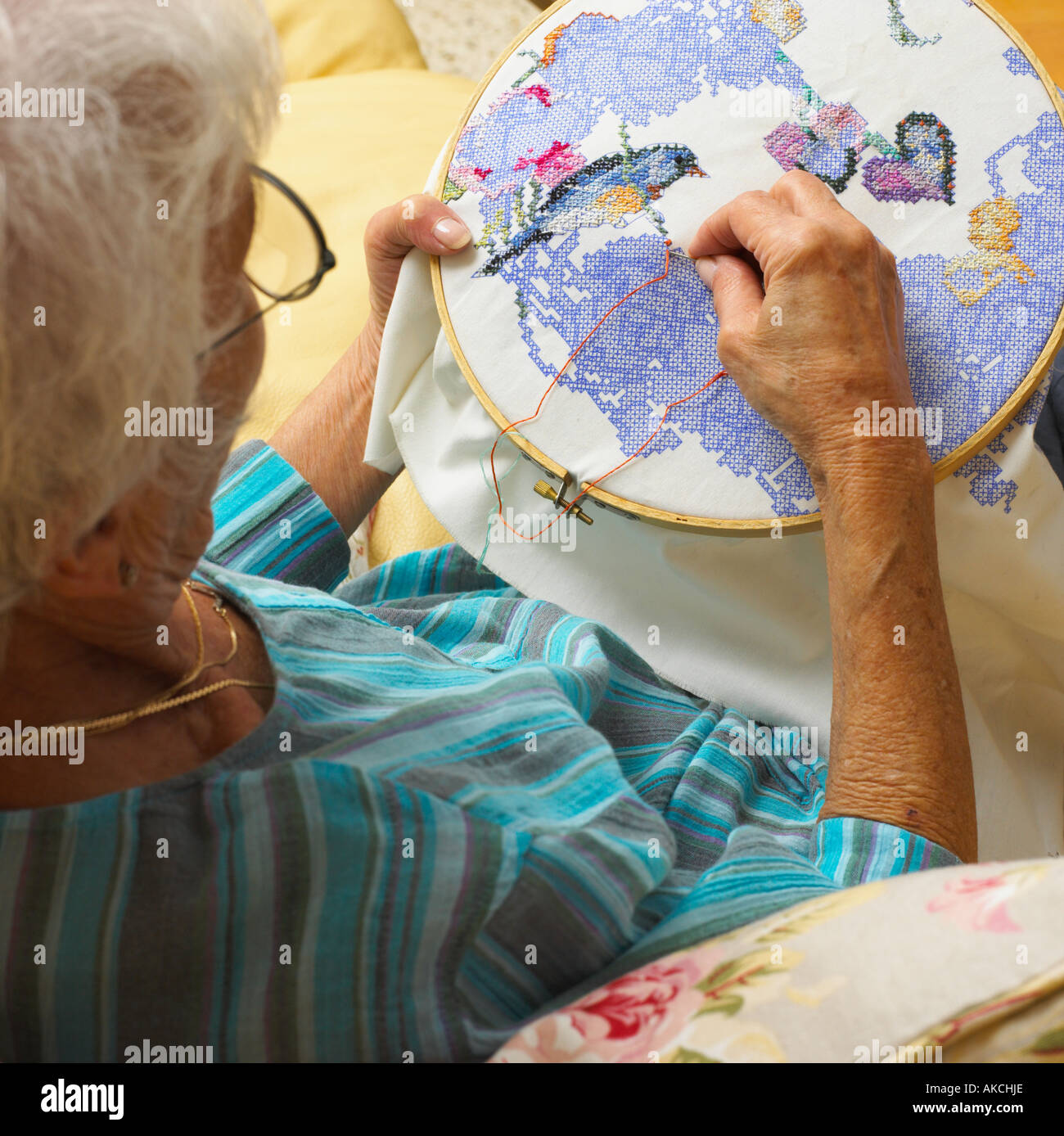Mature woman with needlepoint Stock Photo - Alamy