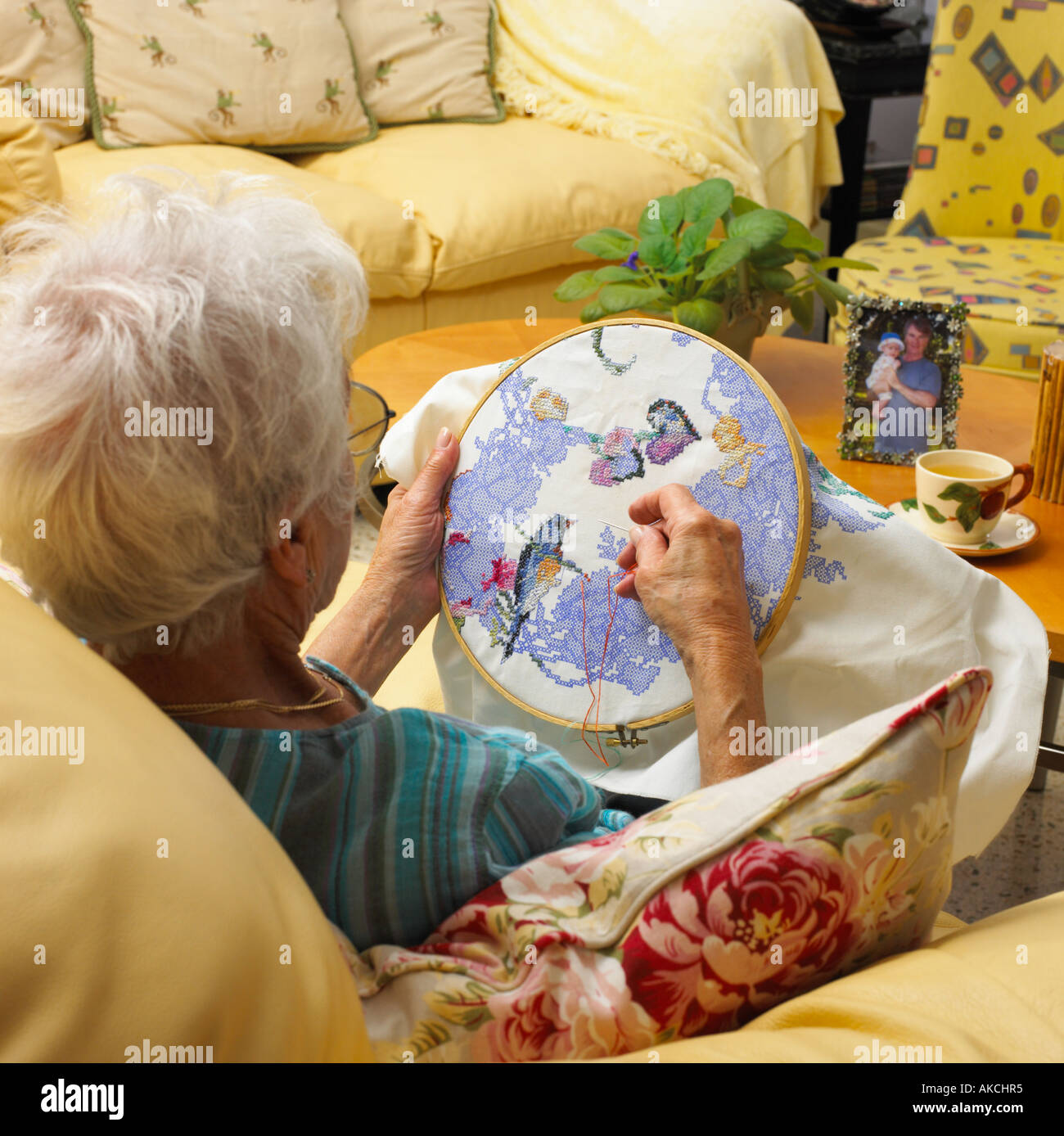 Mature woman with needlepoint Stock Photo - Alamy
