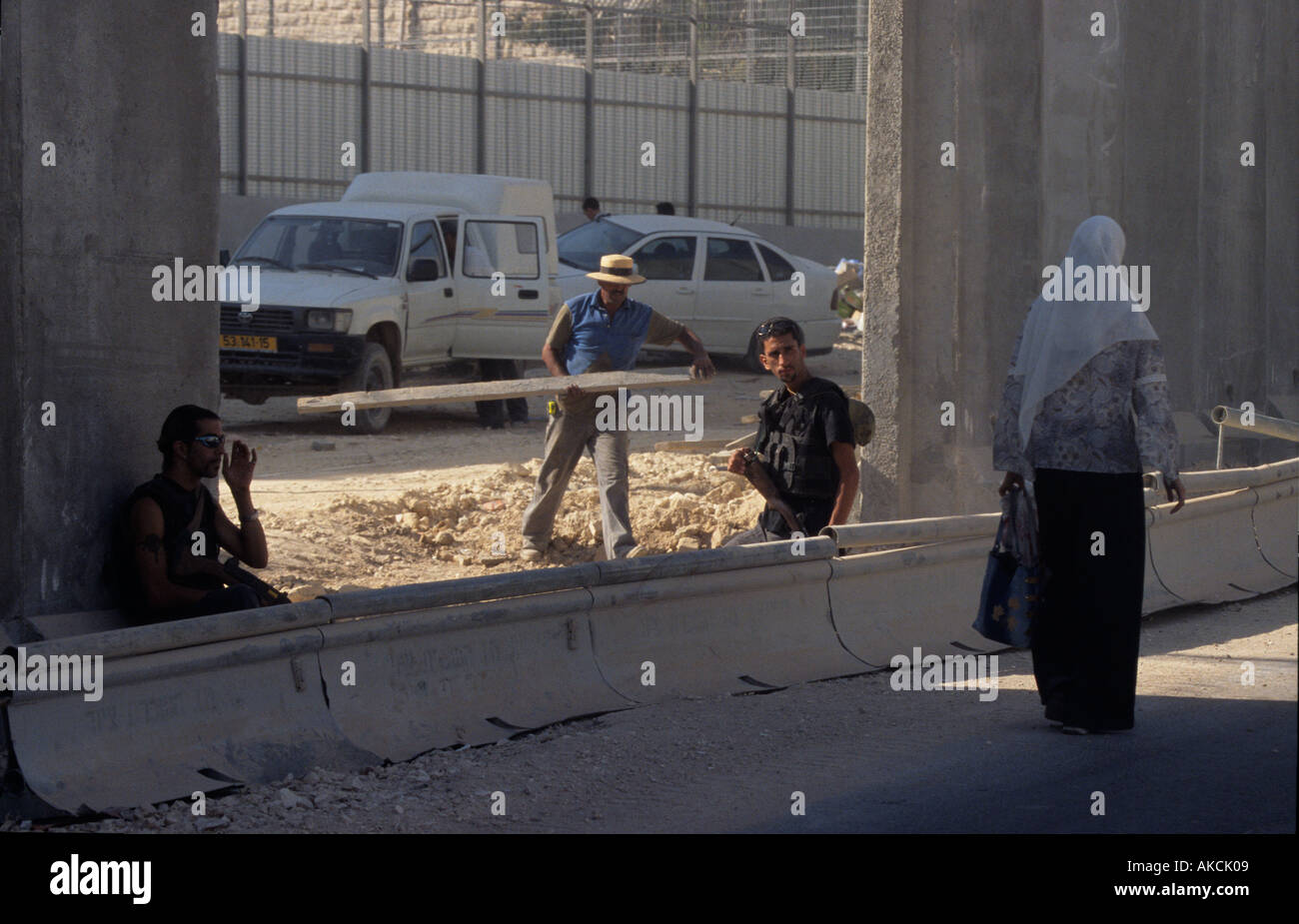 Construction workers working on the Israeli West Bank barrier, West ...