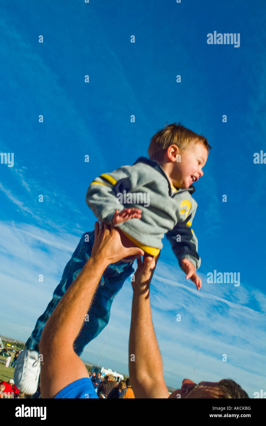 Young boy being thrown into air by father Stock Photo - Alamy