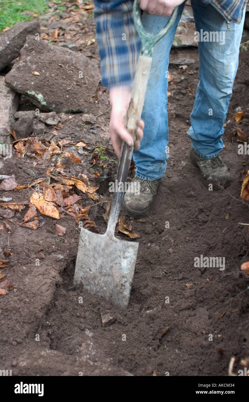 Dry stone walls. Digging out a foundation level Stock Photo - Alamy