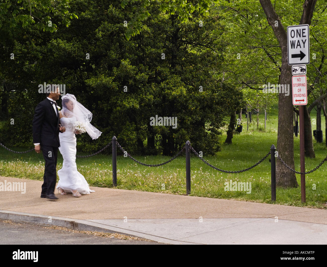 Bride and Groom Walk Past One-Way Sign Stock Photo - Alamy