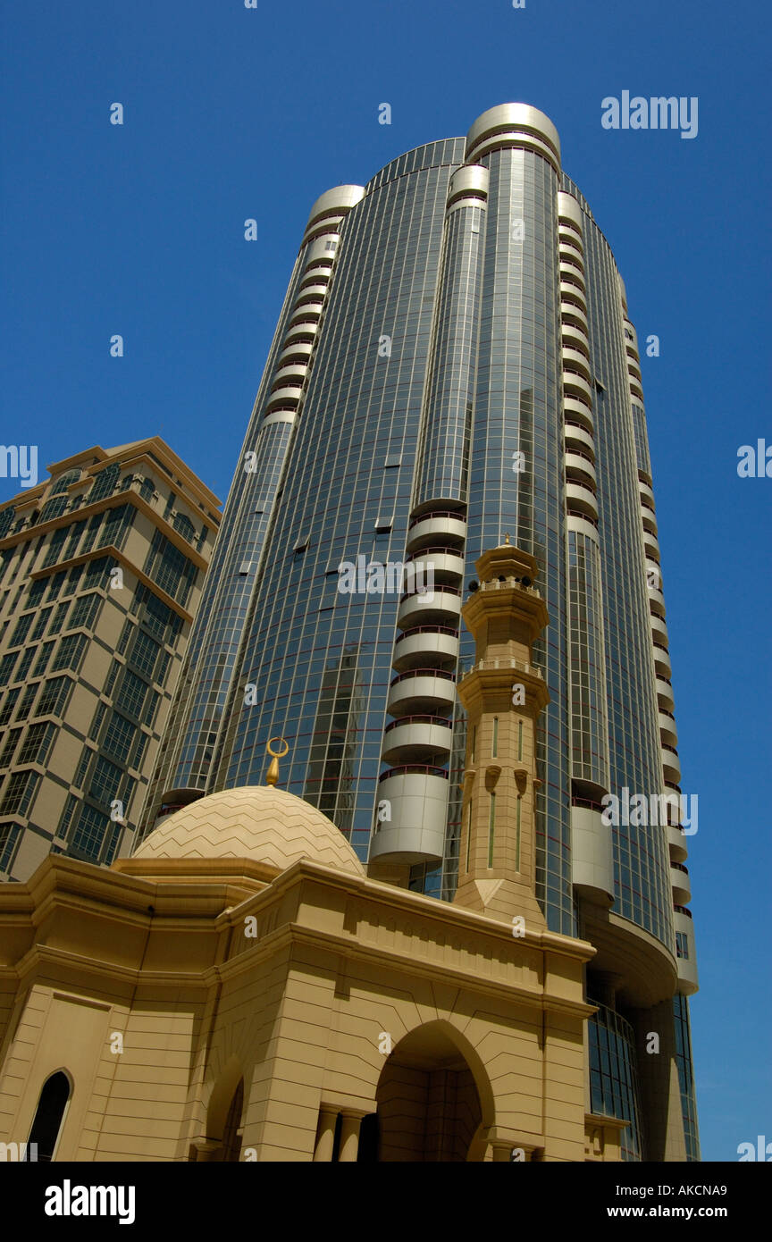 Mosque and modern high rise building in Abu Dhabi UAE Stock Photo - Alamy