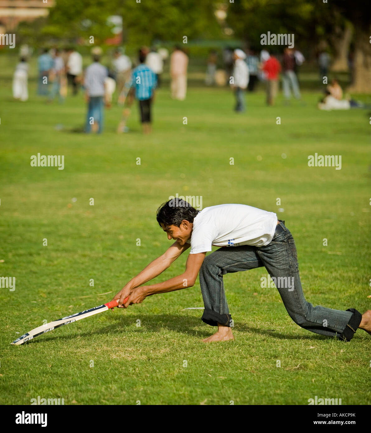 A young Indian guy stretches to get back to the crease while playing ...