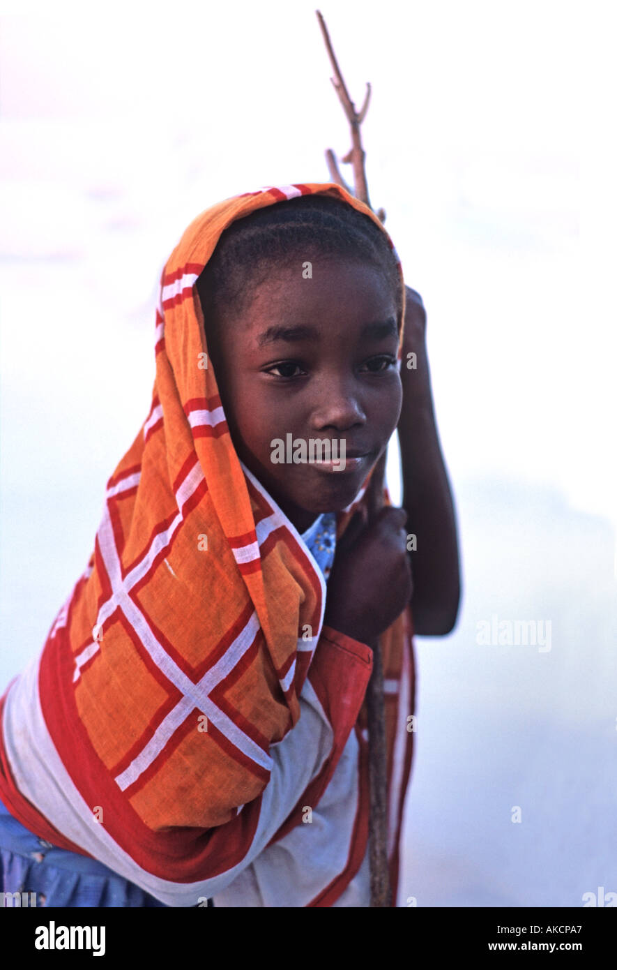 Cheerful Zanzibari girl wearing a kanga cloth over her head Nungwi ...