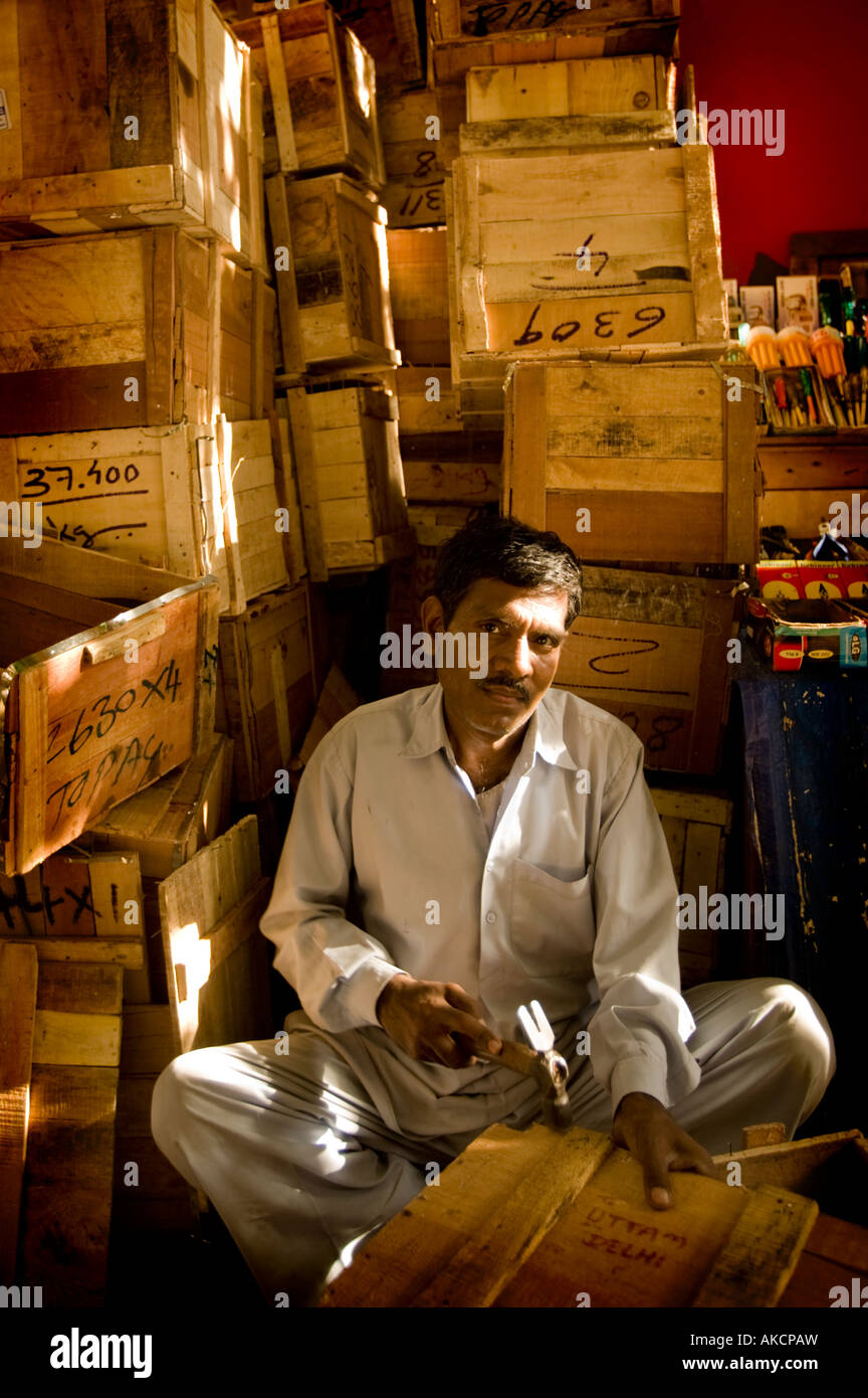A portrait of Indian carpenter making wooden crates in Chandni Chowk ...