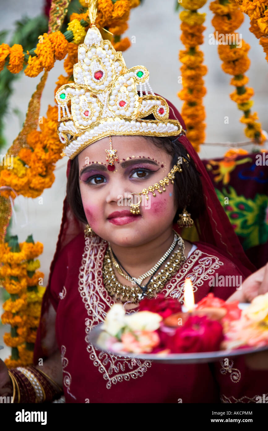 A young girl wearing elaborate traditional dress in celebration of the ...