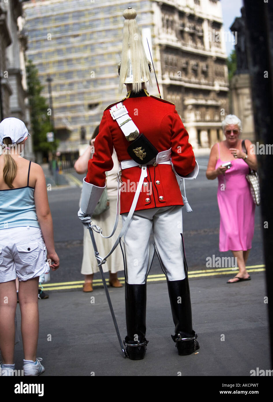 A young girl stands behind a solider of the Life Guards Regiment on ...