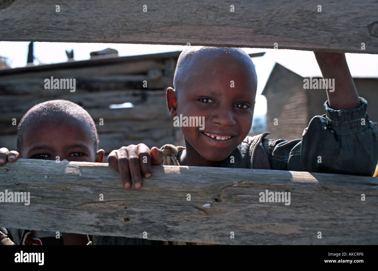 Masai boys behind a wooden fence North of Arusha en route to southern ...