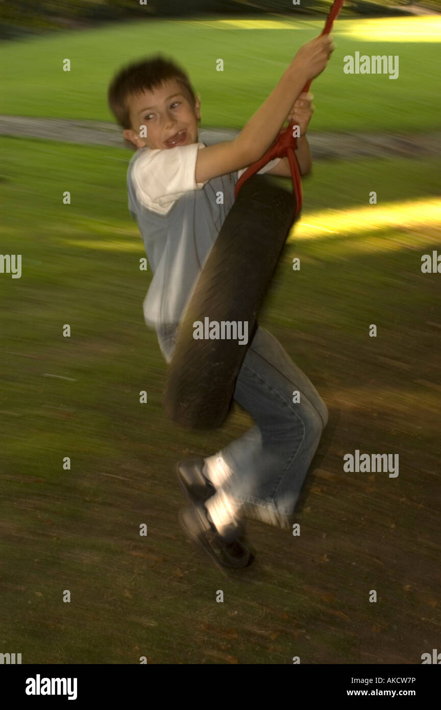 Boy On Swing showing movement in uk Stock Photo - Alamy