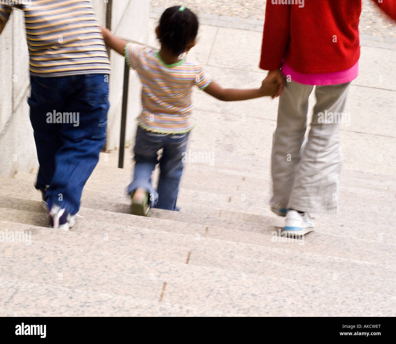 Young children walk down stone steps carefully holding hands for safety ...