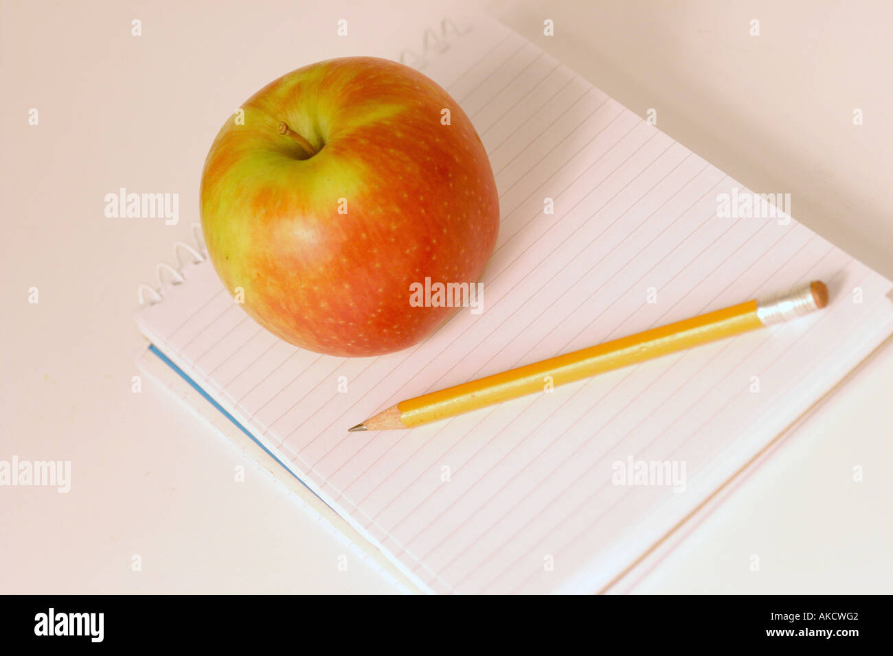 A Stock Photograph of a apple notepad and pencil representing returning ...