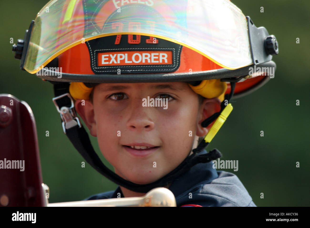 Young Fire Fighter Explorer riding the back of the engine Stock Photo ...