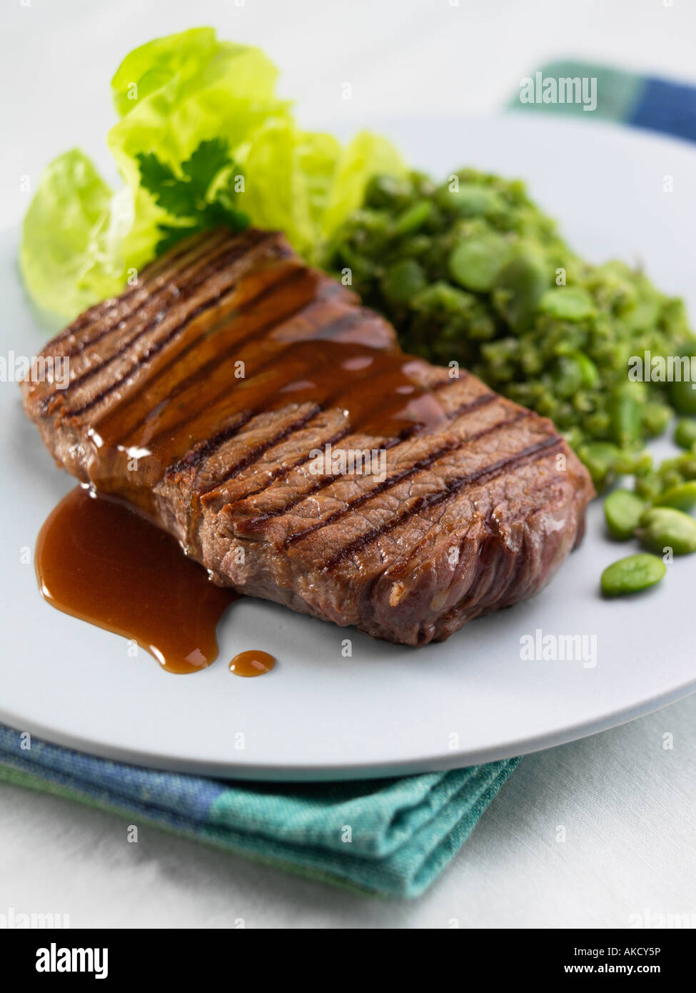 A plate of sirloin steak and mashed broad beans editorial diet food ...