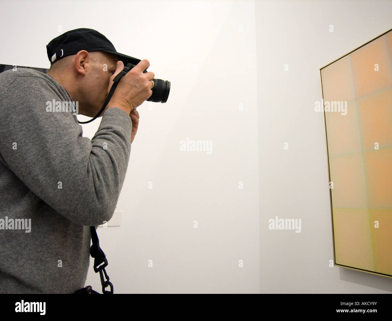 visitor man viewing and photographing art objeckts in museum Stock ...