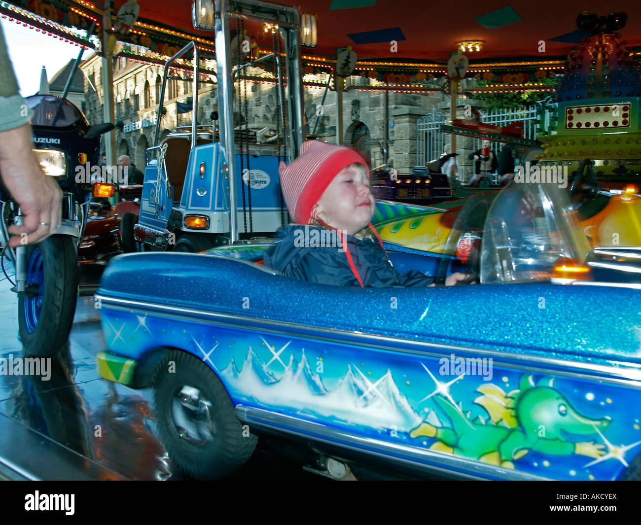 little weeping child driving in a car of kids merry go round roundabout ...