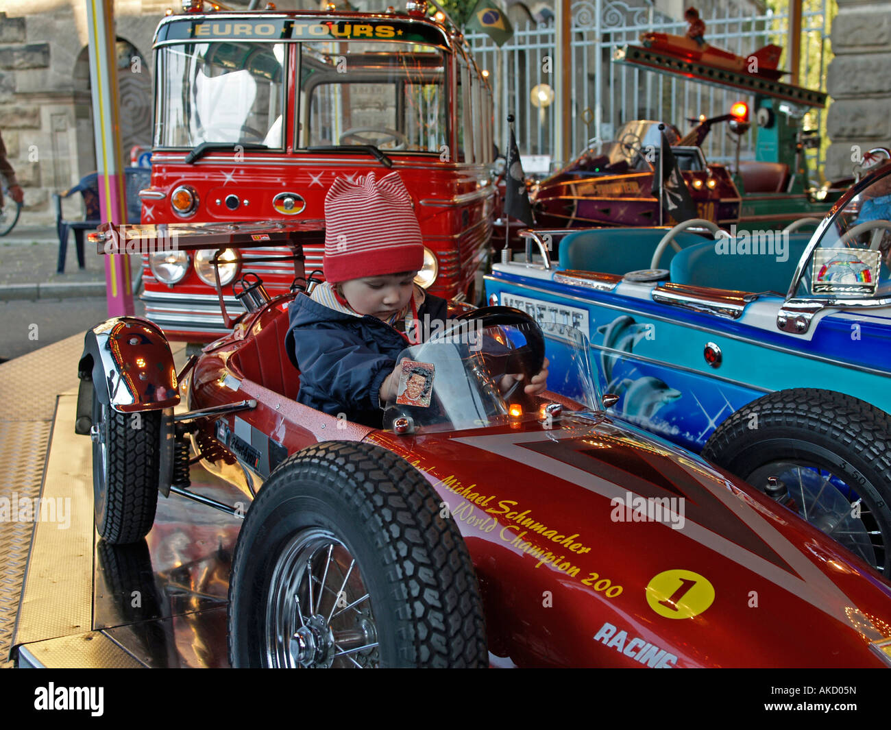 little child driving in a car of kids merry go round roundabout Stock ...