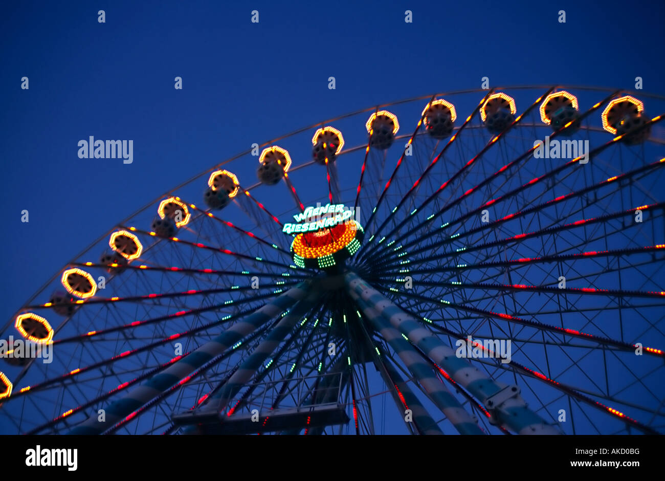 fair with lightened racing amusement ferries wheel rides in different ...