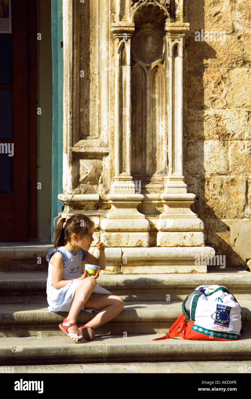South-East Europe, Croatia, Dubrovnik, Girl (8-9) sitting on entrance ...