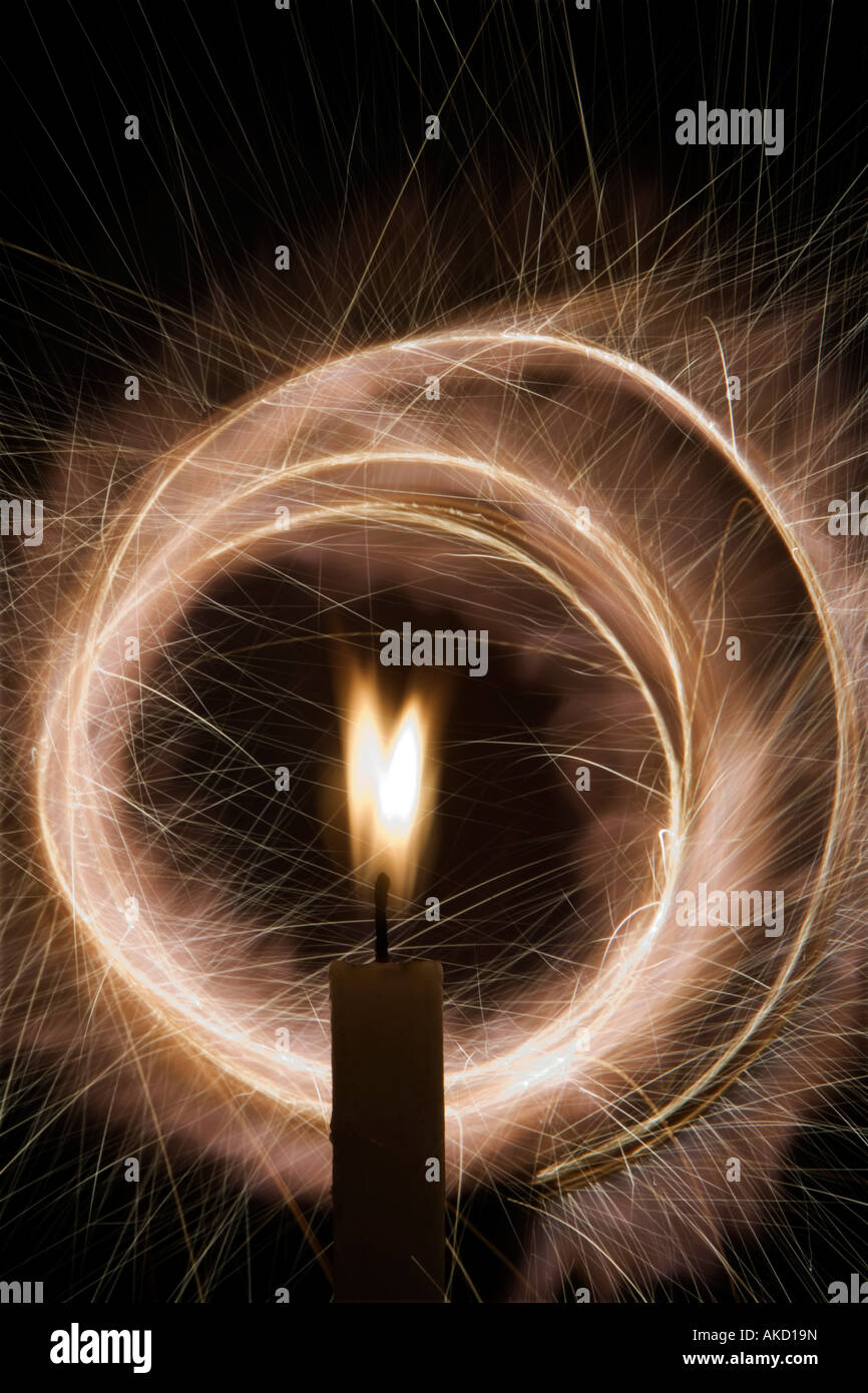 Candle light with circular light spark trails at night Stock Photo - Alamy